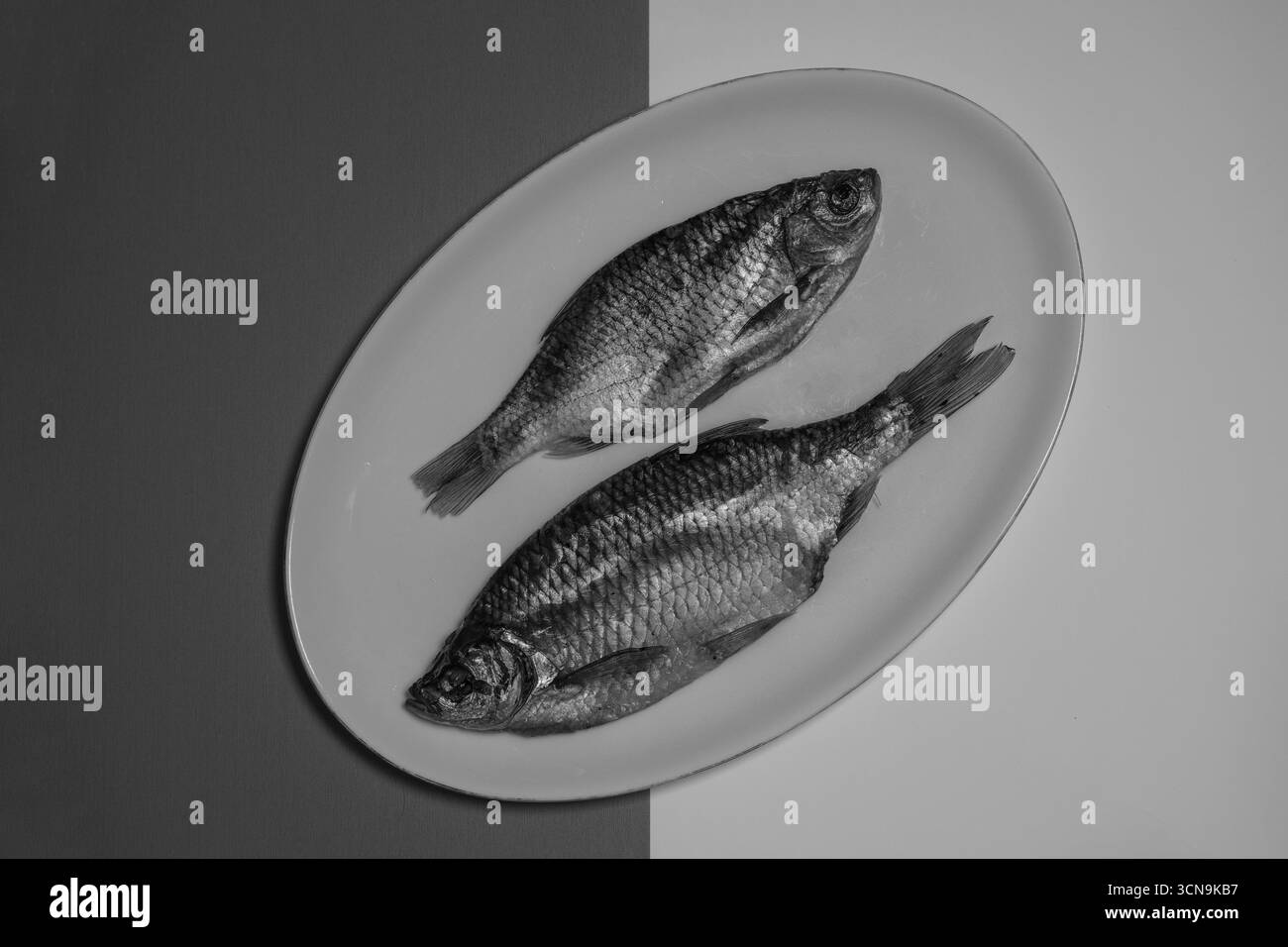 White fish on plate Black and White Stock Photos & Images - Alamy