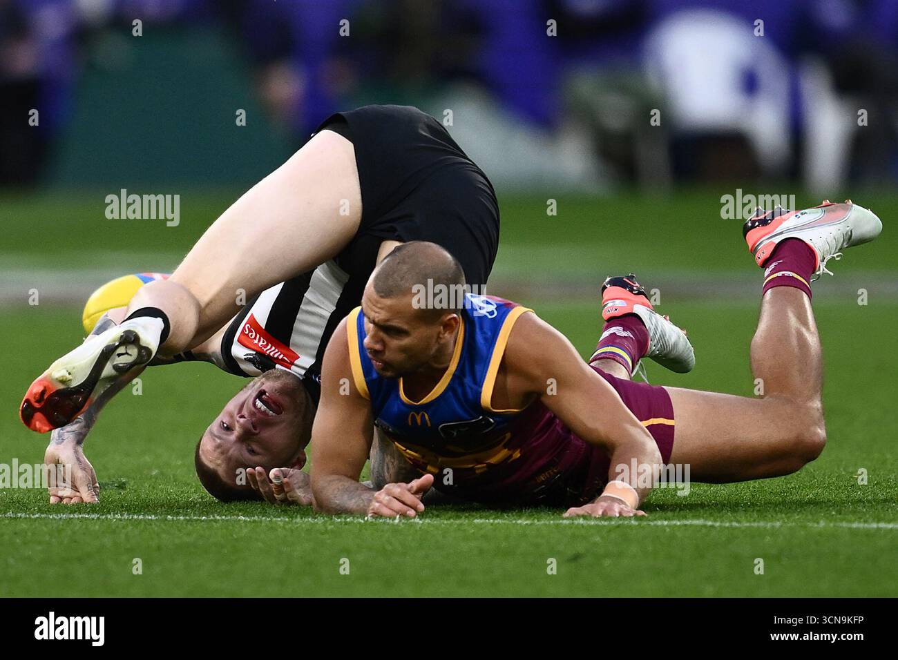 Callum Ah Chee of the Lions tackles Jordan De Goey of Collingwood ...