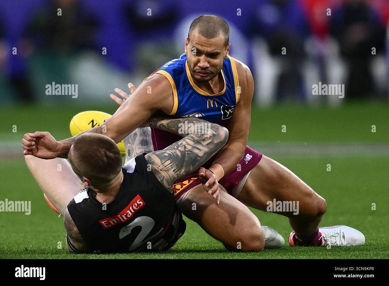 Callum Ah Chee of the Lions tackles Jordan De Goey of Collingwood ...