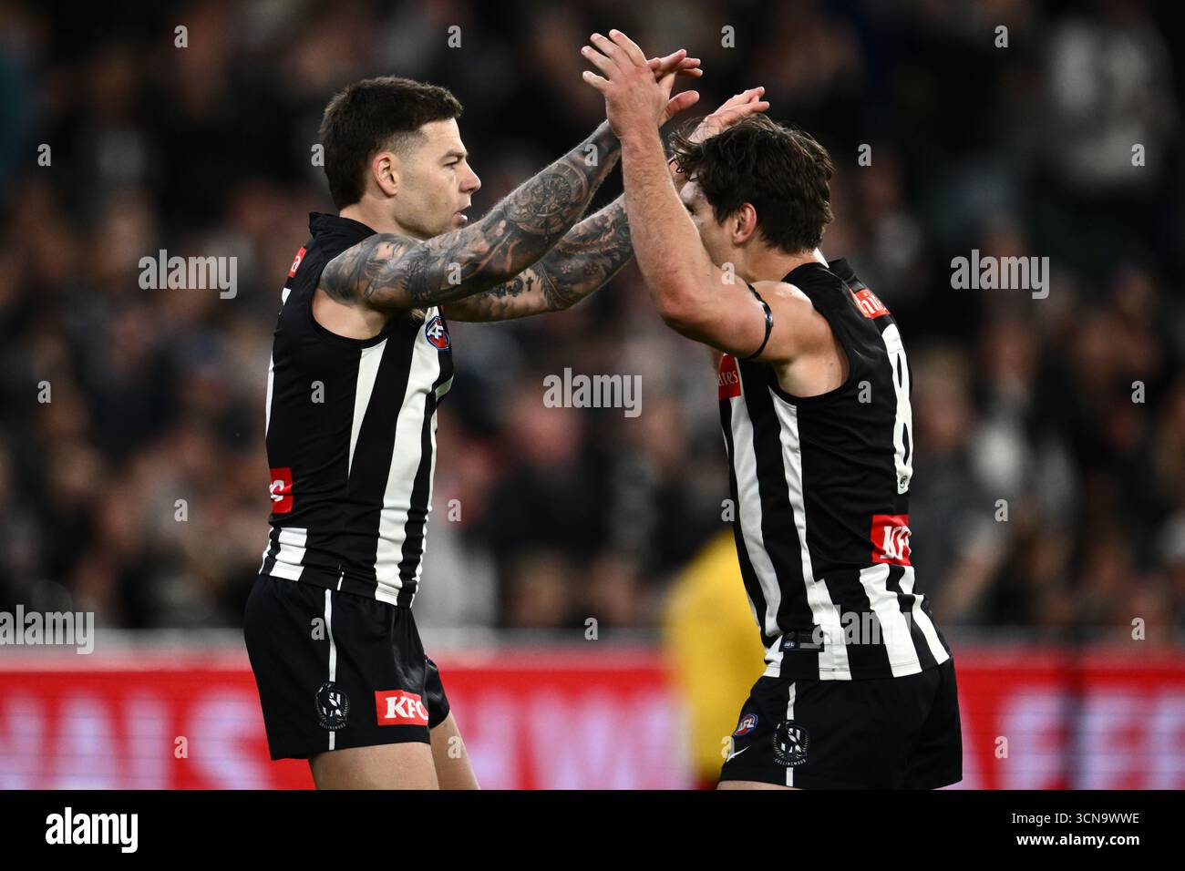 Jamie Elliott of Collingwood celebrates scoring a goal with Lachie ...