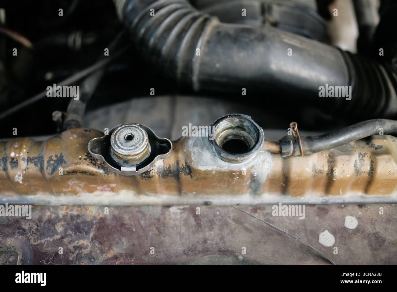 Close up of car radiator with cap open to check the coolant water level ...