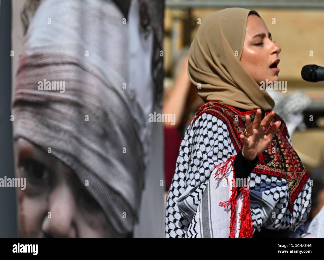20 September 2025, Berlin: Singer Wafaa sings during a rally before the ...