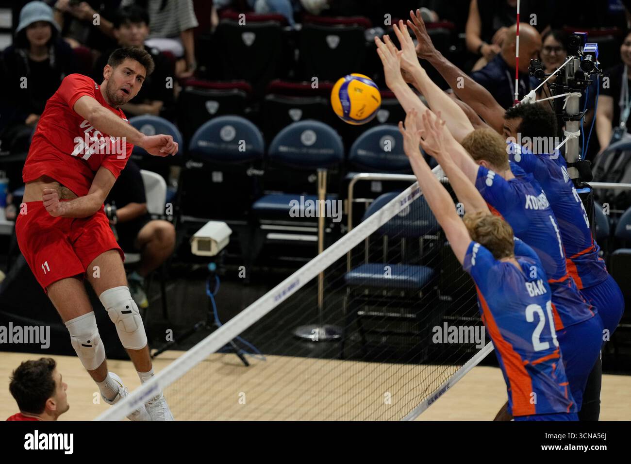 Mirza Lagumdzija, left, of Turkey hits the ball against Netherlands ...