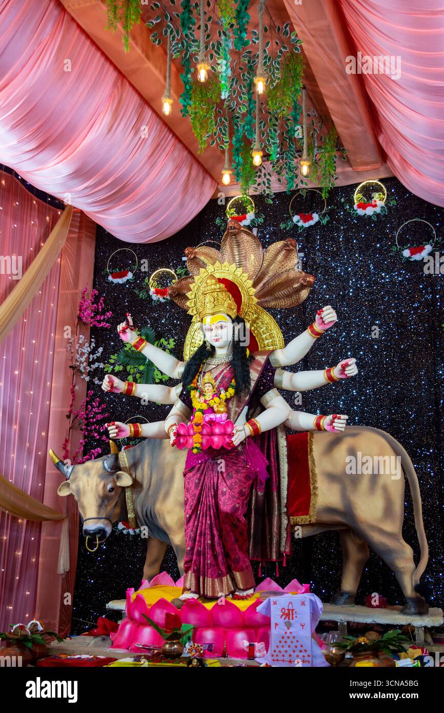 Beautifully decorated idol of Goddess Durga placed in a festive pandal ...
