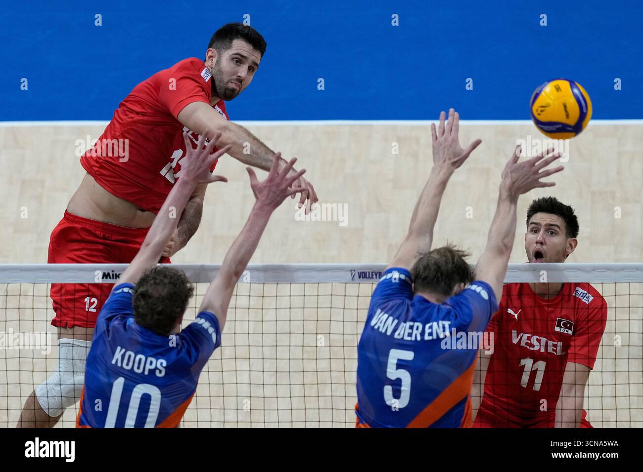 Adis Lagumdzija, left, of Turkey spikes the ball against Cornelis Luuc ...