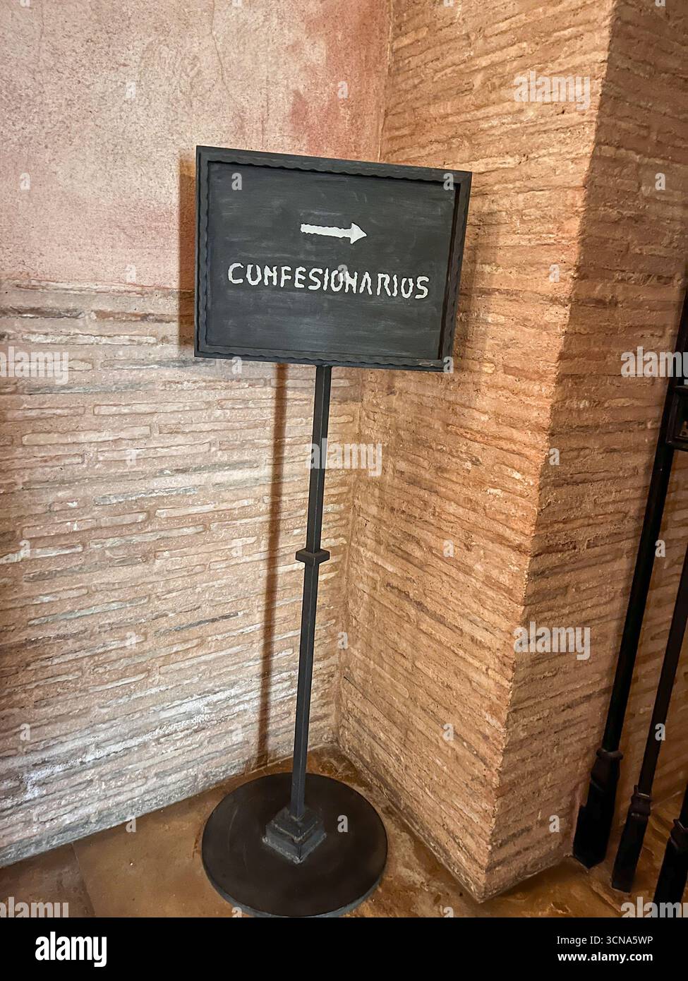 Sign in a spanish church indicates location of confesionals Stock Photo ...