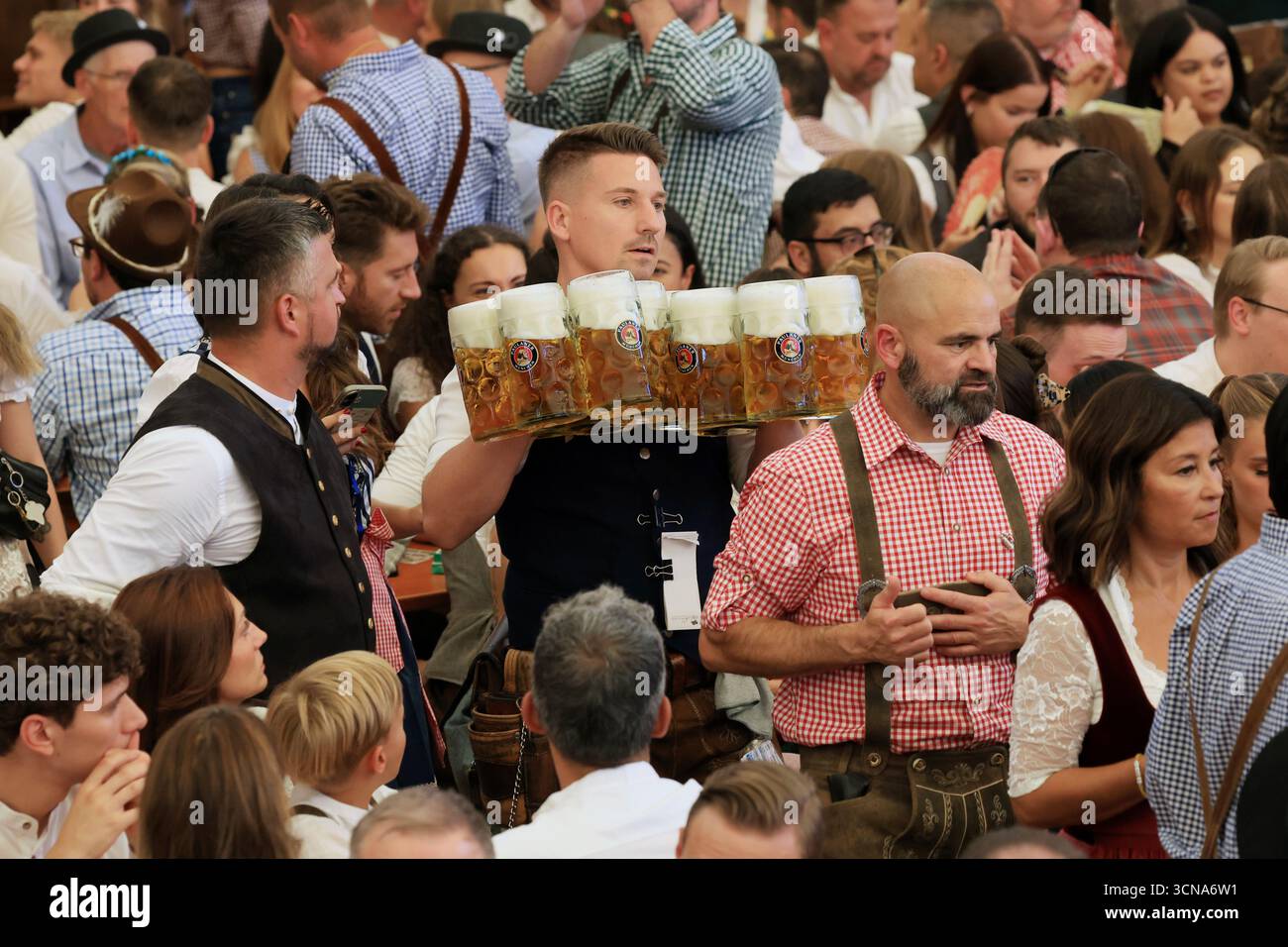 The first beers are distributed to visitors in the Paulaner beer tent ...