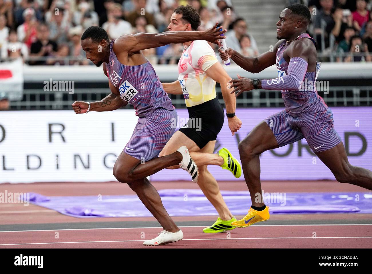 United States' Christian Coleman passes the baton to teammate Rosie ...