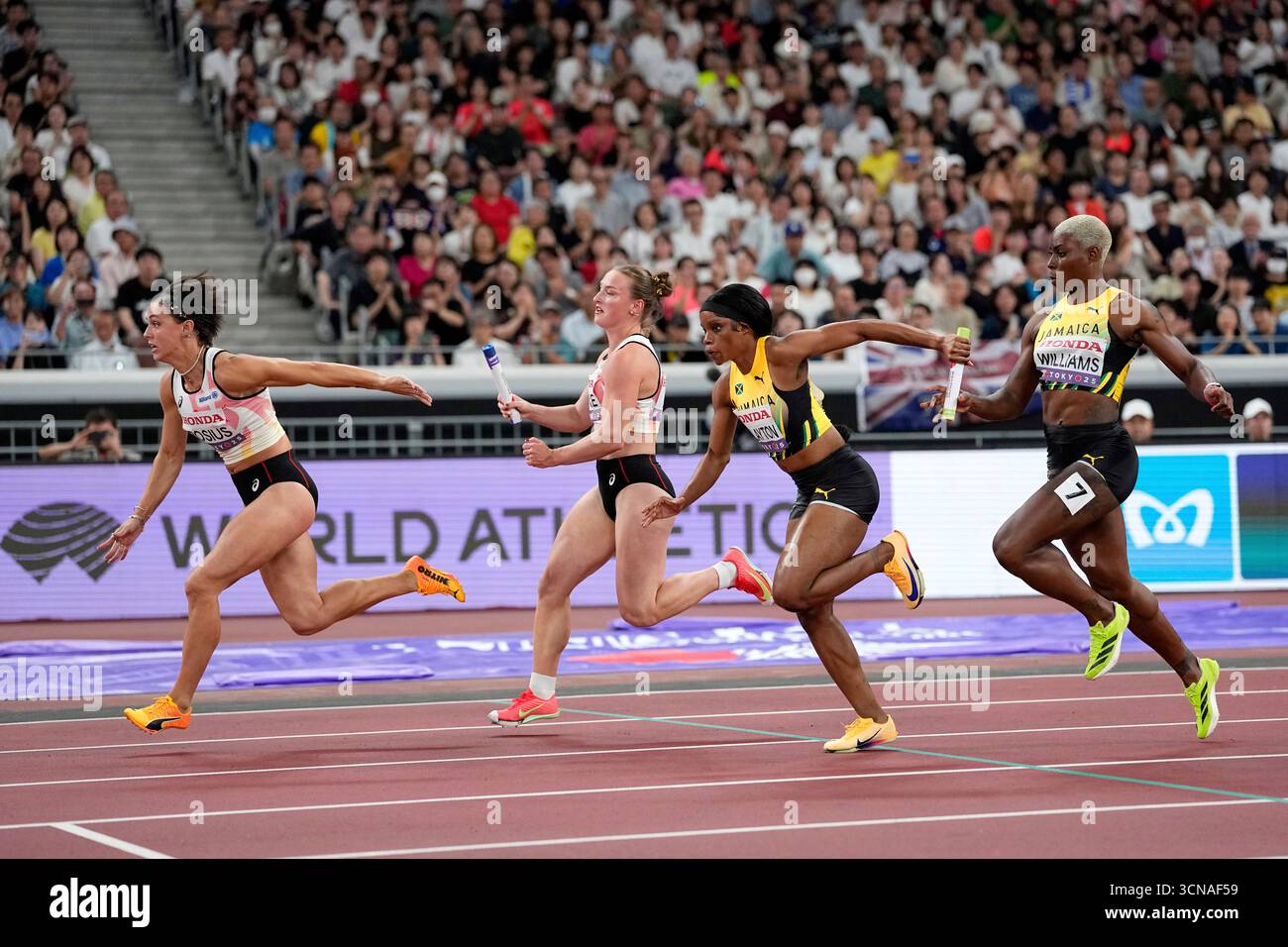 Jamaica's Jordan Williams passes the baton to teammate Tia Clayton ...