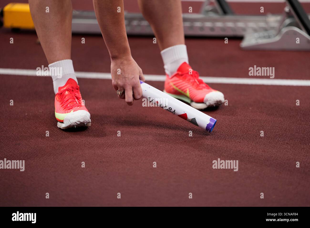 Belgium's Rani Vincke picks up a baton before a women's 4 X 100 meters ...