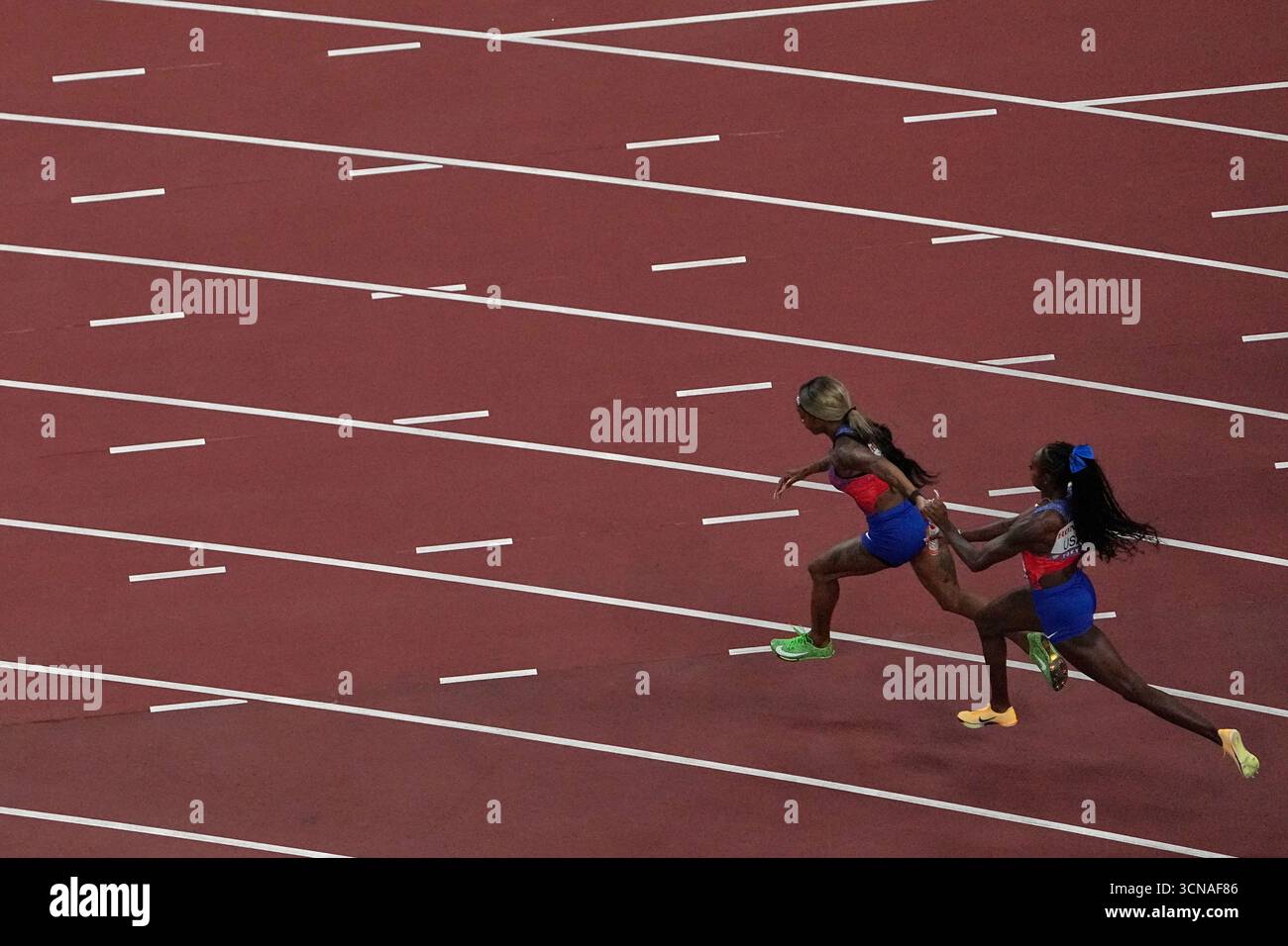 United States' Kayla White, right, exchanges the baton with Sha'Carri ...