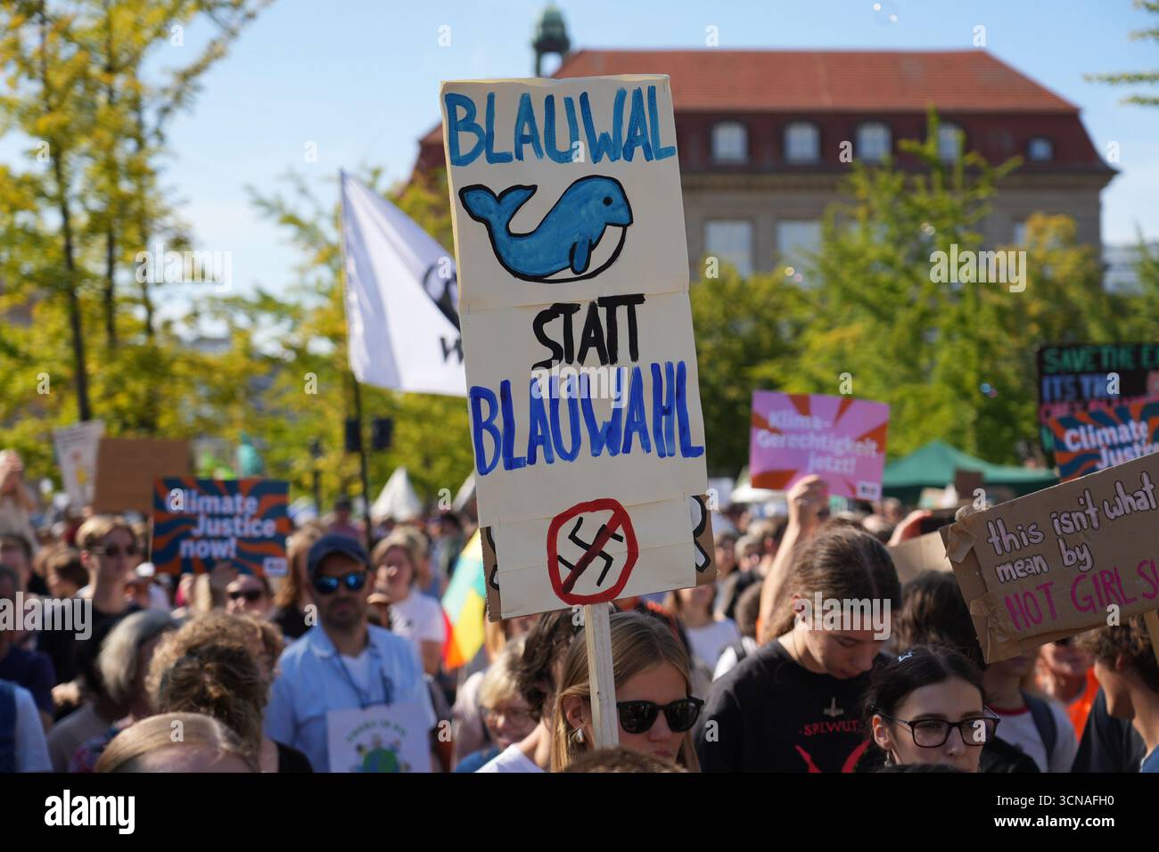 20 September 2025, Berlin: A demonstrator holds up a placard with the ...