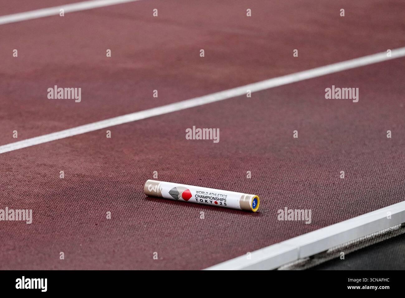 A baton lies on the track during a women's 4 X 100 meters relay heat at ...
