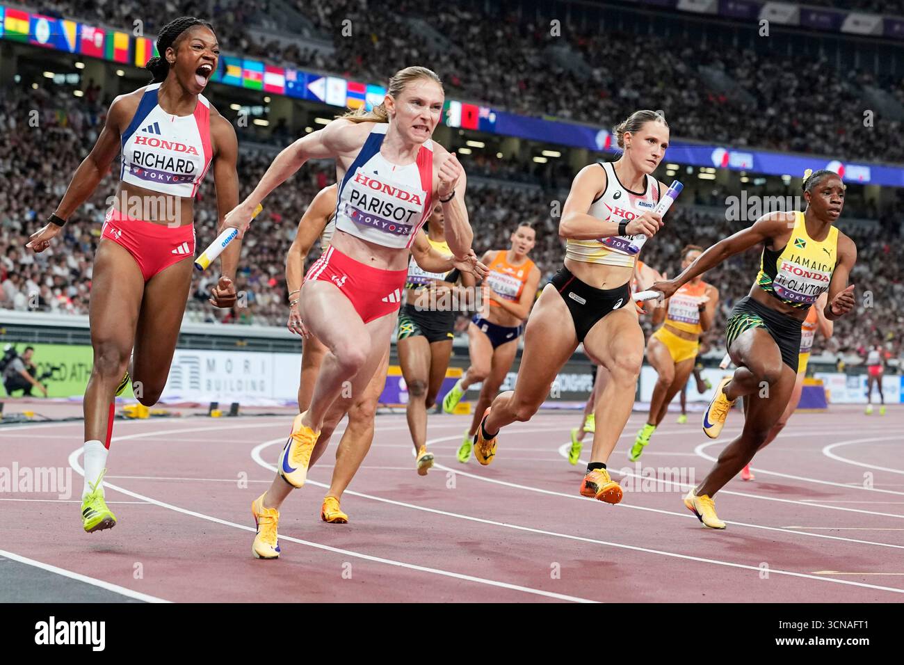 France's Sarah Richard, left, reacts after passing the baton to ...