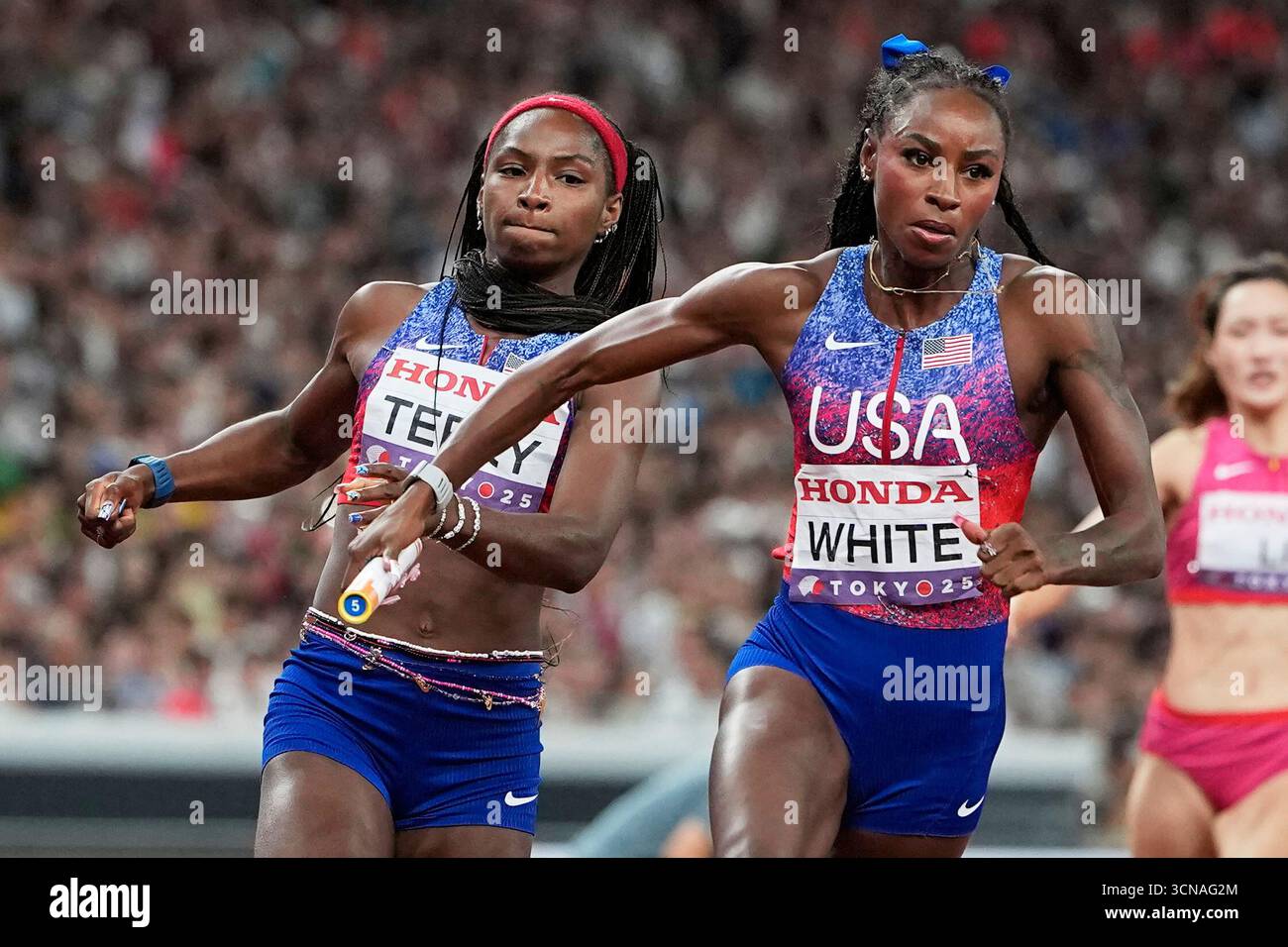 United States' Kayla White, right, takes the baton from teammate ...