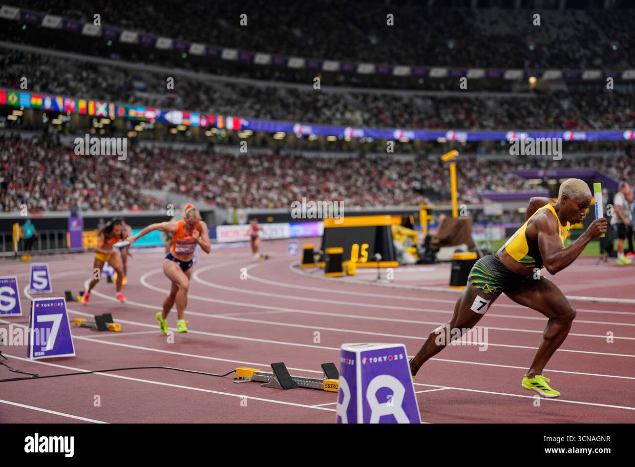 Athletes compete in a women's 4 X 100 meters relay heat at the World ...