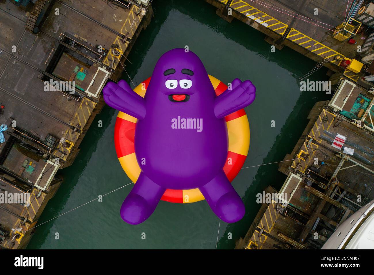 An aerial photograph showing large inflatable Grimace Sculpture at a ...