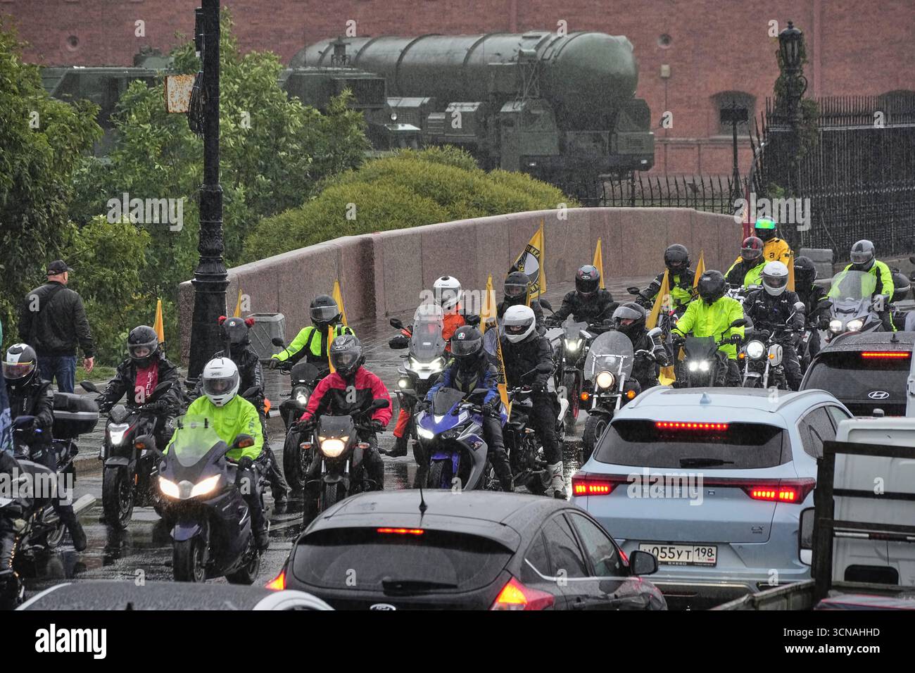 Motorcyclists ride during rainfall past a Russian intercontinental ...