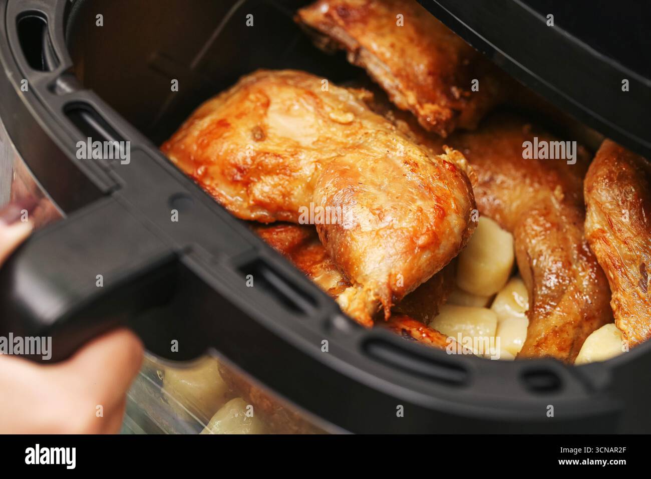Fried chicken in air fryer. Modern kitchen appliance with crispy food ...