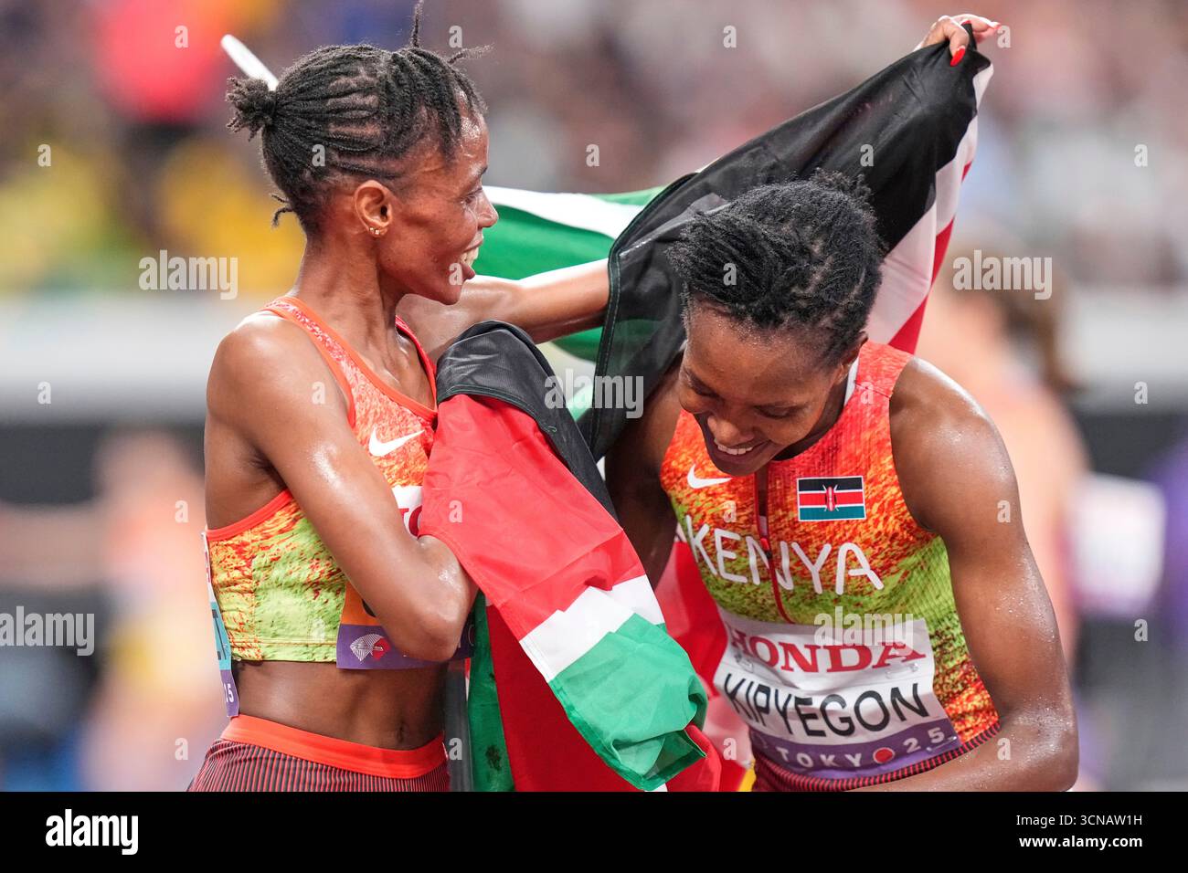 Kenya's Beatrice Chebet reacts with Kenya's Faith Kipyegon, right ...