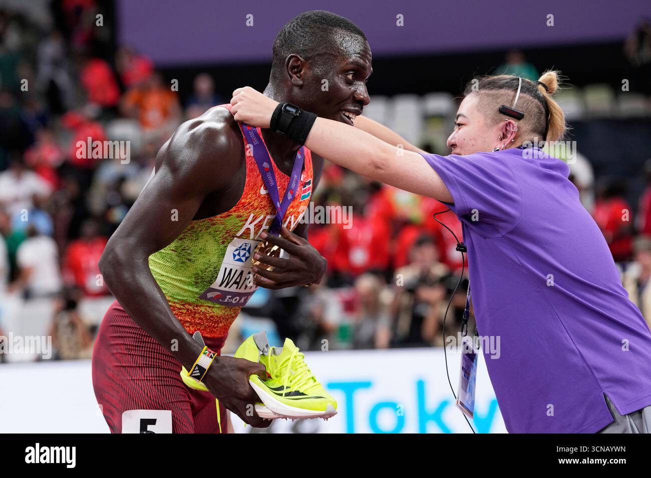 Kenya's Emmanuel Wanyonyi is presented with his gold medal after ...