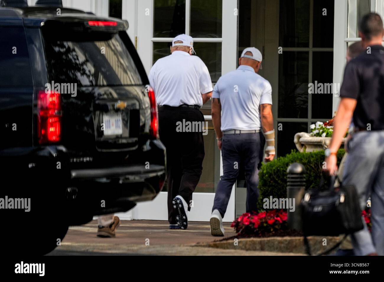 President Donald Trump, from left, and personal aide Walt Nauta arrive ...