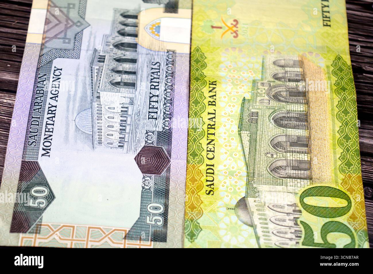 the reverse sides of old and new 50 SAR fifty Saudi Arabian riyals cash ...