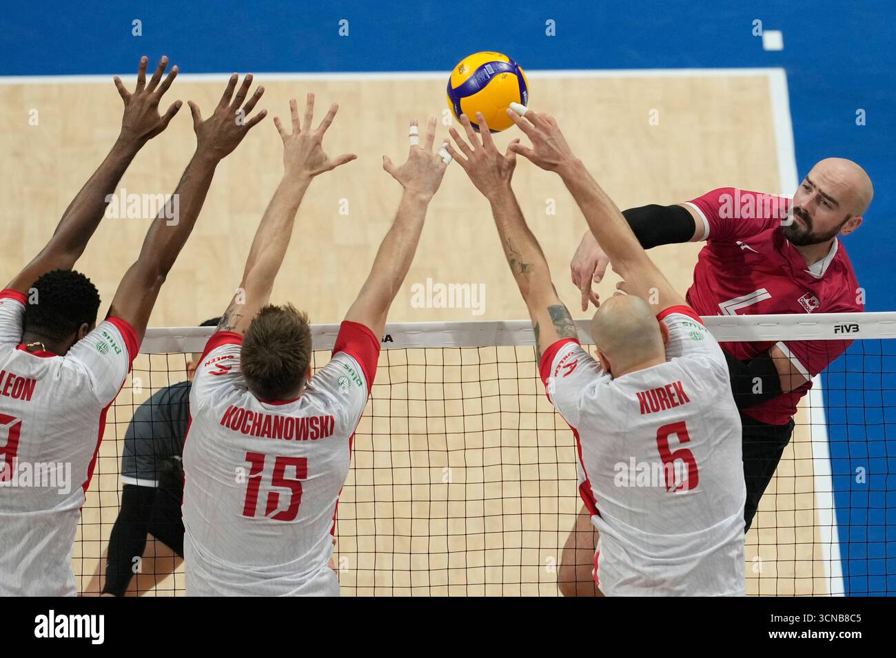 Nicholas Hoag, right, of Canada hits the ball against Poland during ...