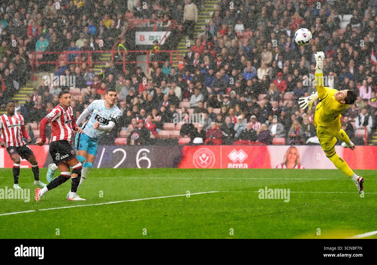Sheffield United goalkeeper Michael Cooper makes a save from the shot ...