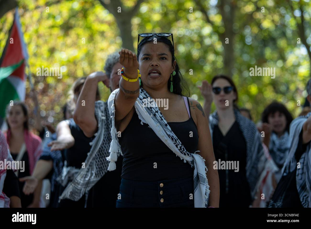A woman makes protest signs with her hands at a demonstration. Feminist ...