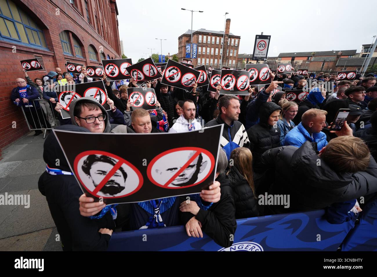 Campaigners hold signs opposing Rangers head coach Russell Martin and ...