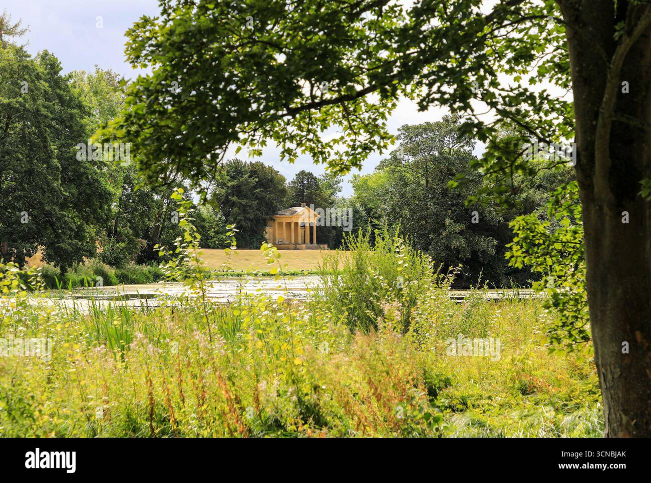 A view through the trees of The Western Lake Pavilion at Stowe House ...