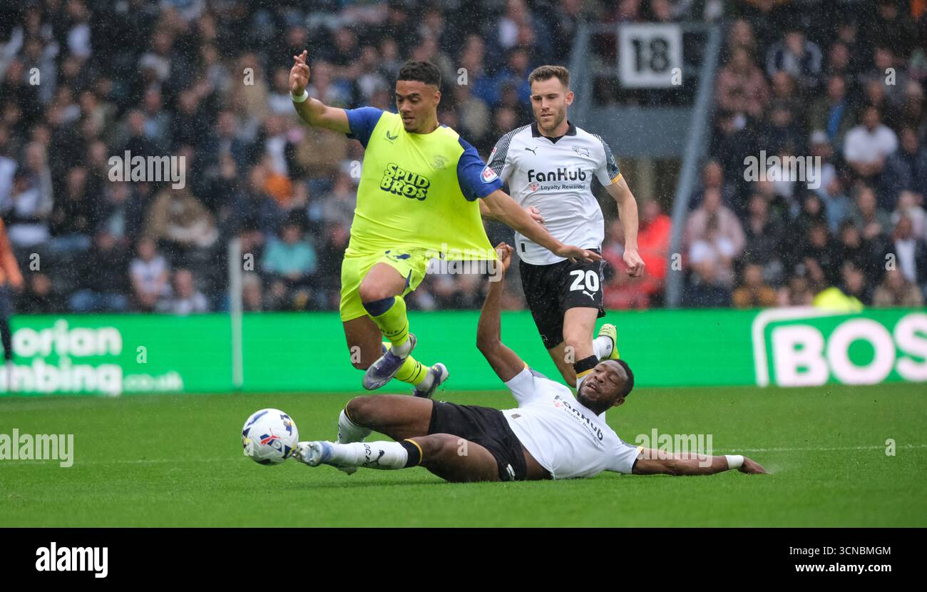 Ebou Adams of Derby County challenges for the ball against Lewis Dobbin ...