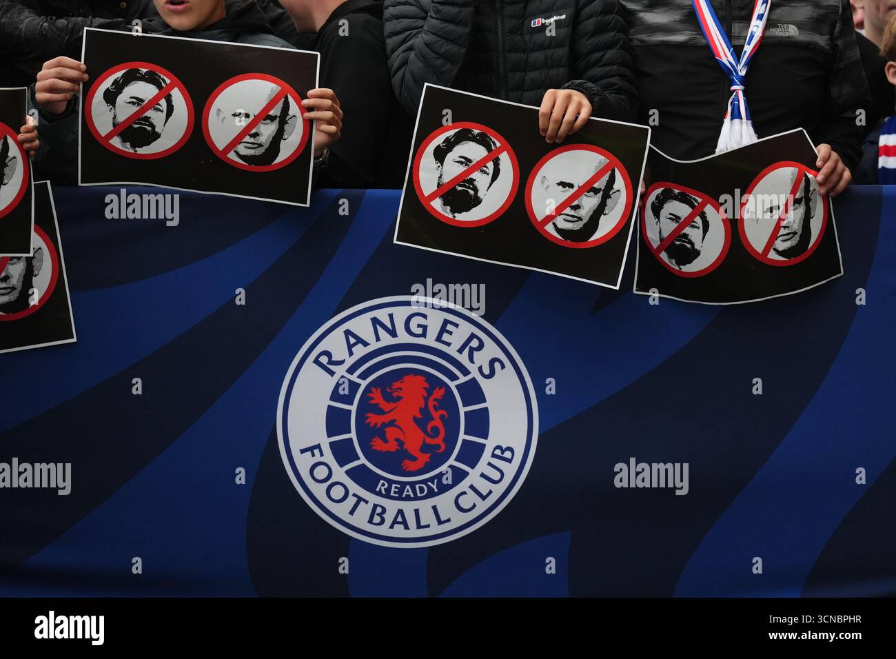 Campaigners hold Rangers banners, and signs opposing Rangers head coach ...