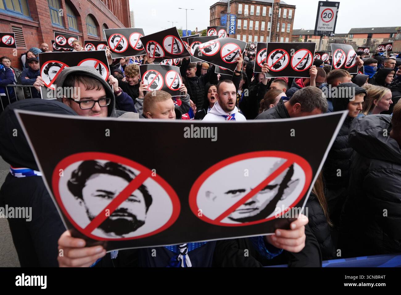 Campaigners hold signs opposing Rangers head coach Russell Martin and ...