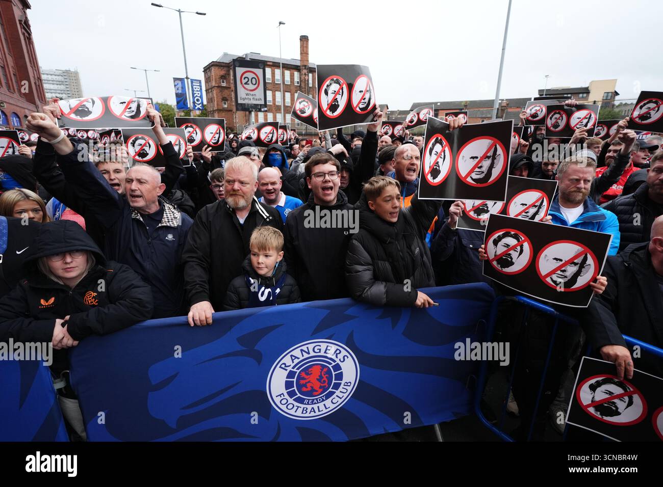 Campaigners hold Rangers banners, and signs opposing Rangers head coach ...