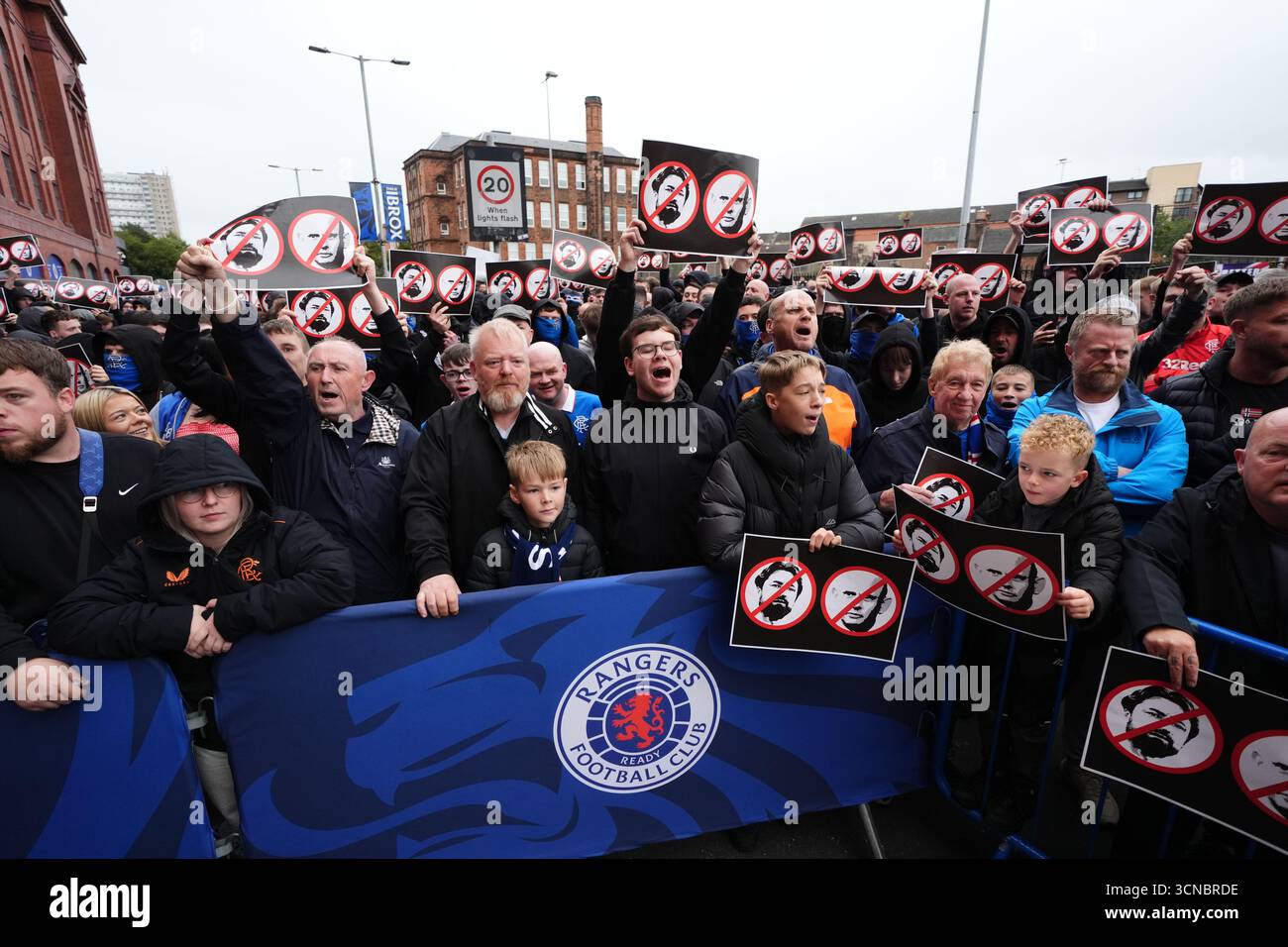 Campaigners hold Rangers banners, and signs opposing Rangers head coach ...