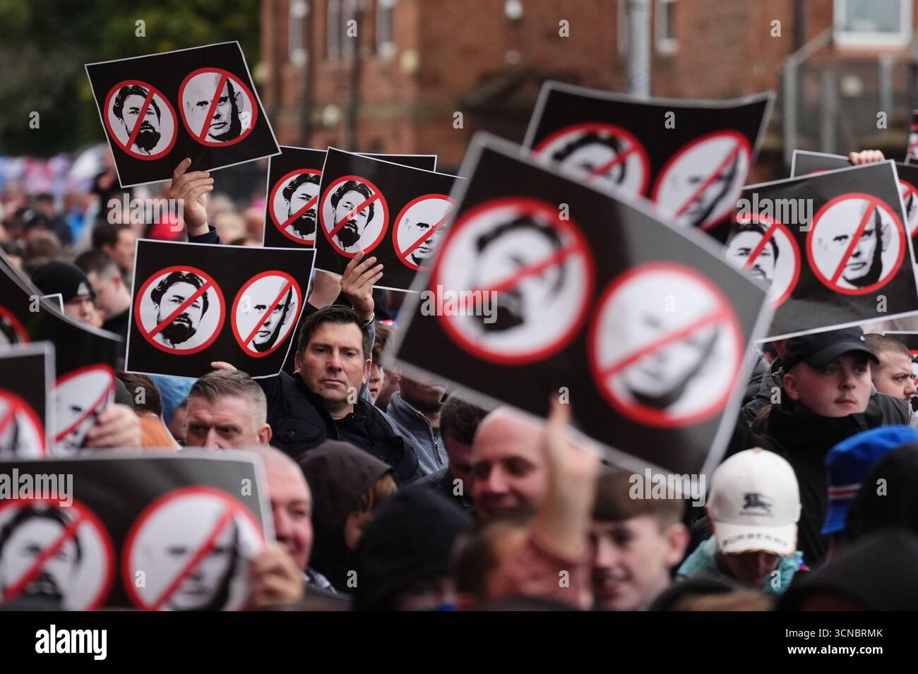 Campaigners hold signs opposing Rangers head coach Russell Martin and ...