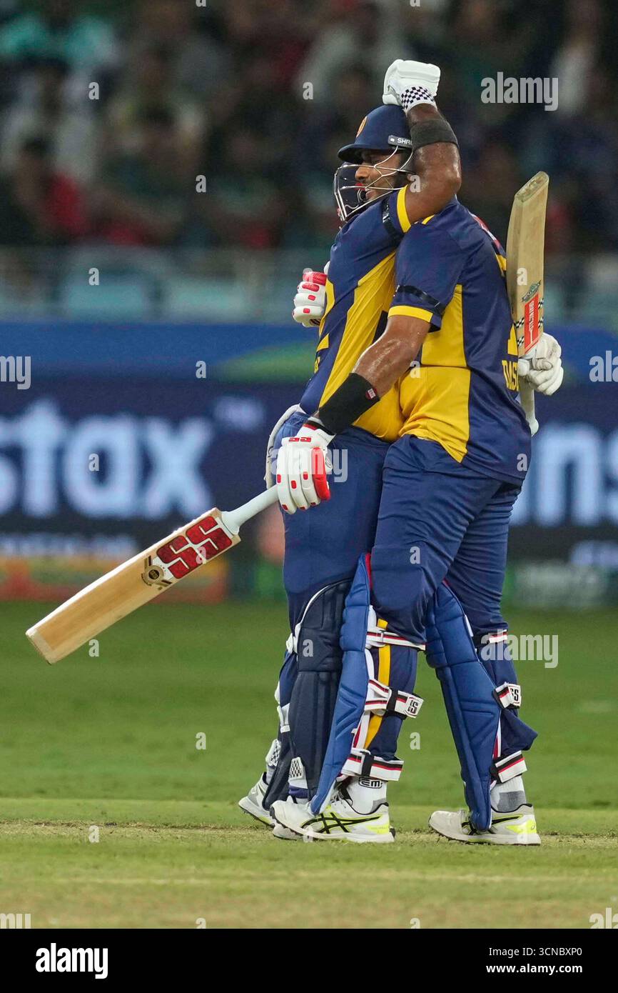 Sri Lanka's captain Charith Asalanka, left, hugs to congratulate ...