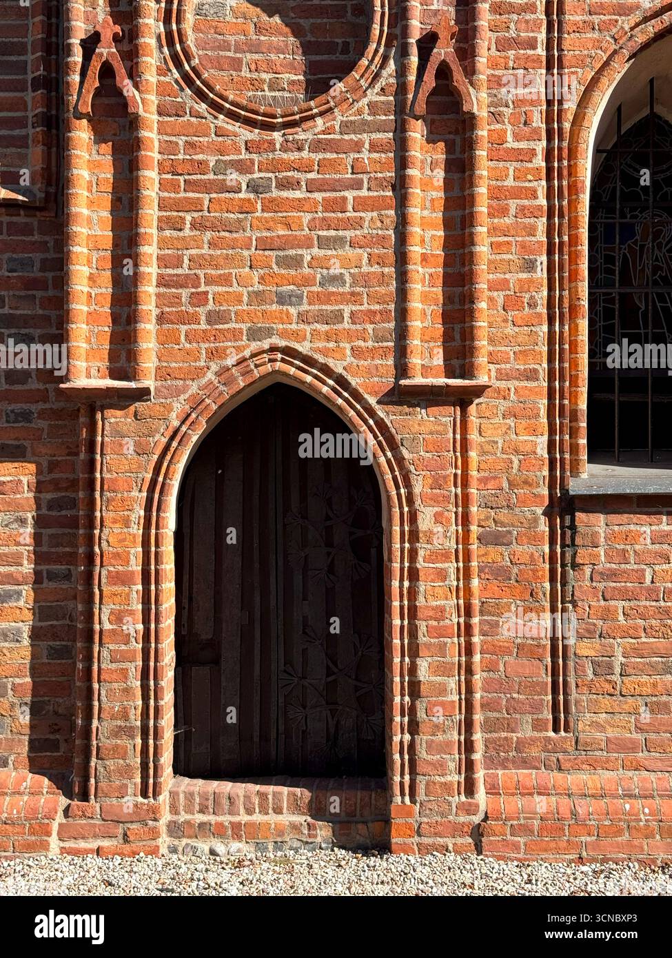 Closeup view of gothic brick church entrance from 1370 in Europe ...