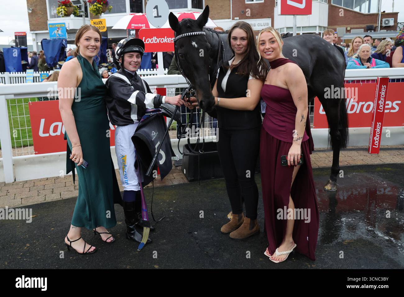 Jockey Lauren Young (second left) on Midnight Lion, after winning The Jordan Electrics during ...