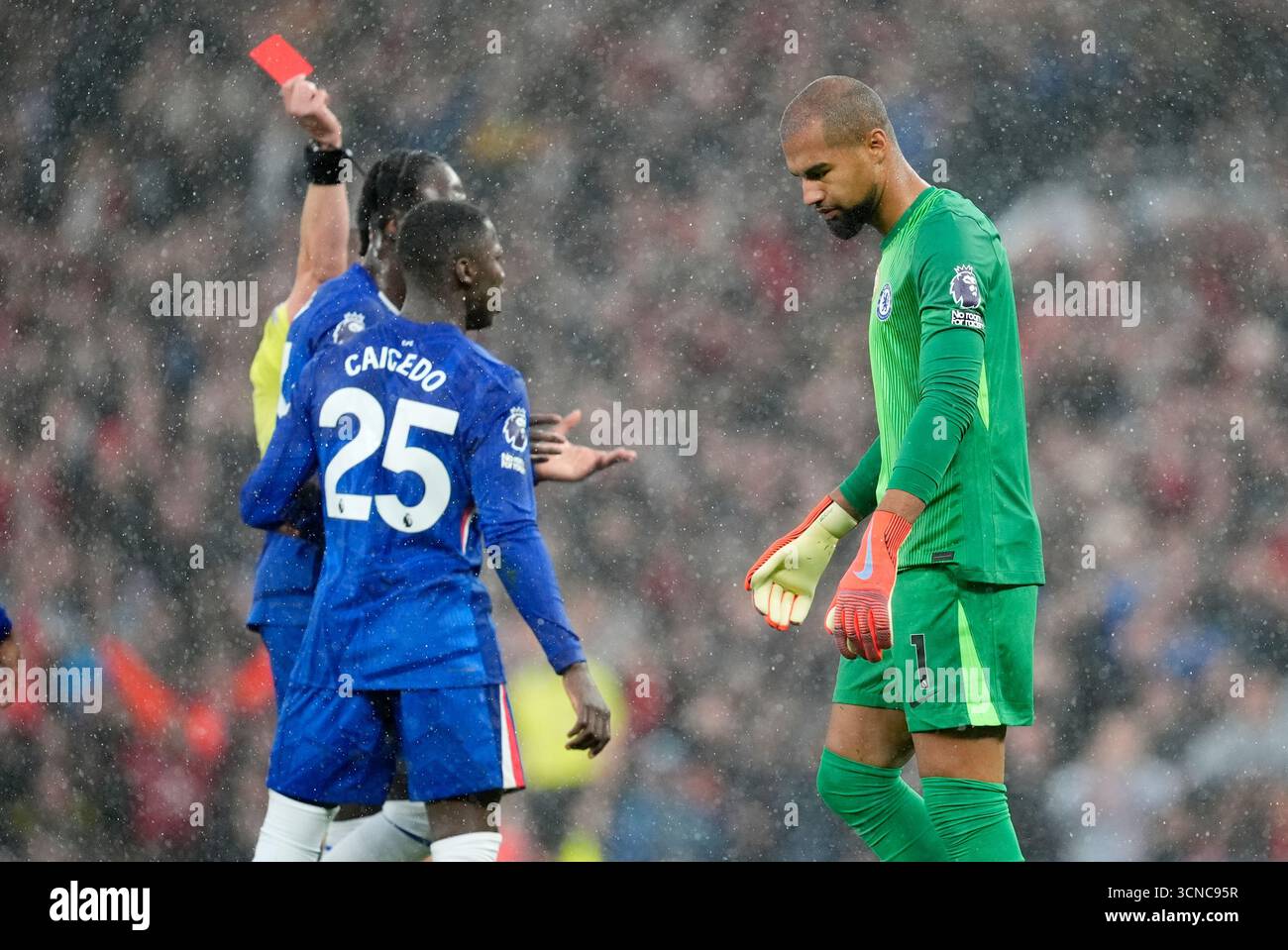 Referee Peter Bankes (obscured) shows Chelsea goalkeeper Robert Sanchez ...