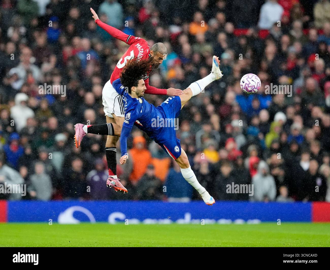 Manchester United's Noussair Mazraoui (left) and Chelsea's Marc Cucurella battle for the ball ...