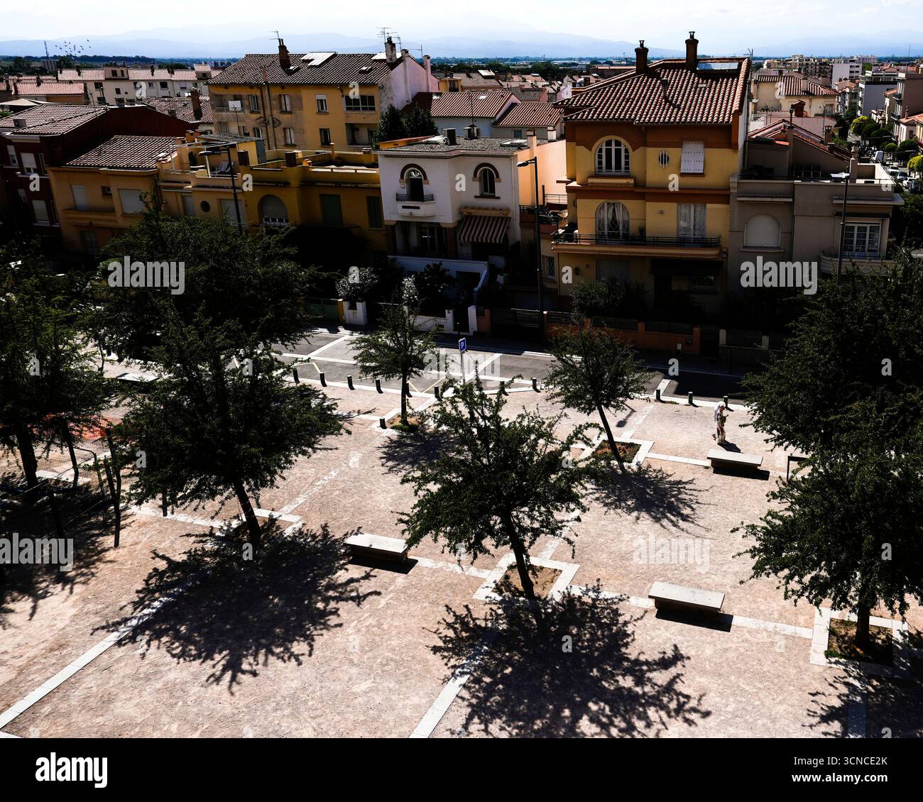 People walk on the sidewalk outside Palace of the Kings of Majorca ...