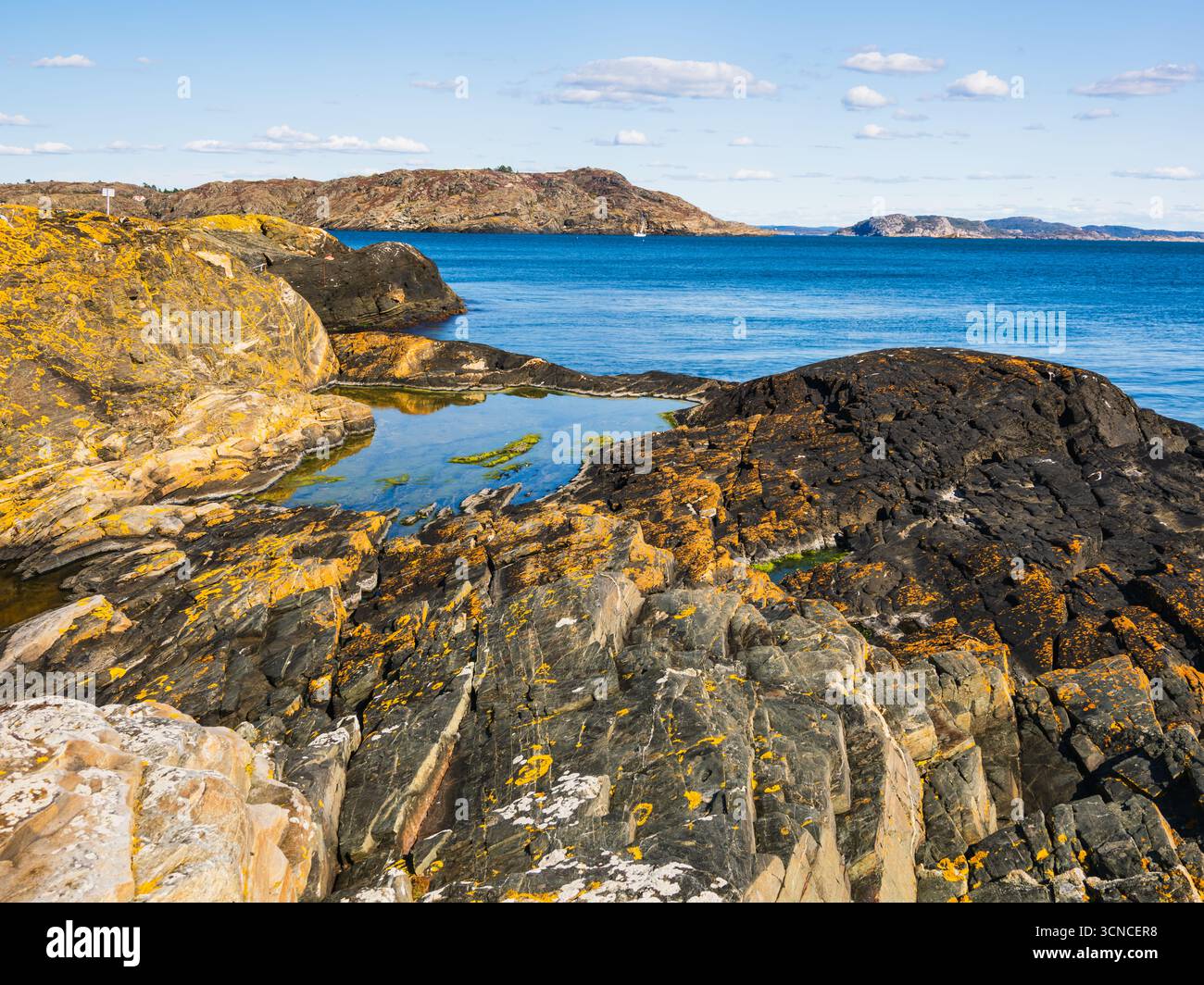 On Åstol island, visitors enjoy the stunning coastal scenery featuring ...