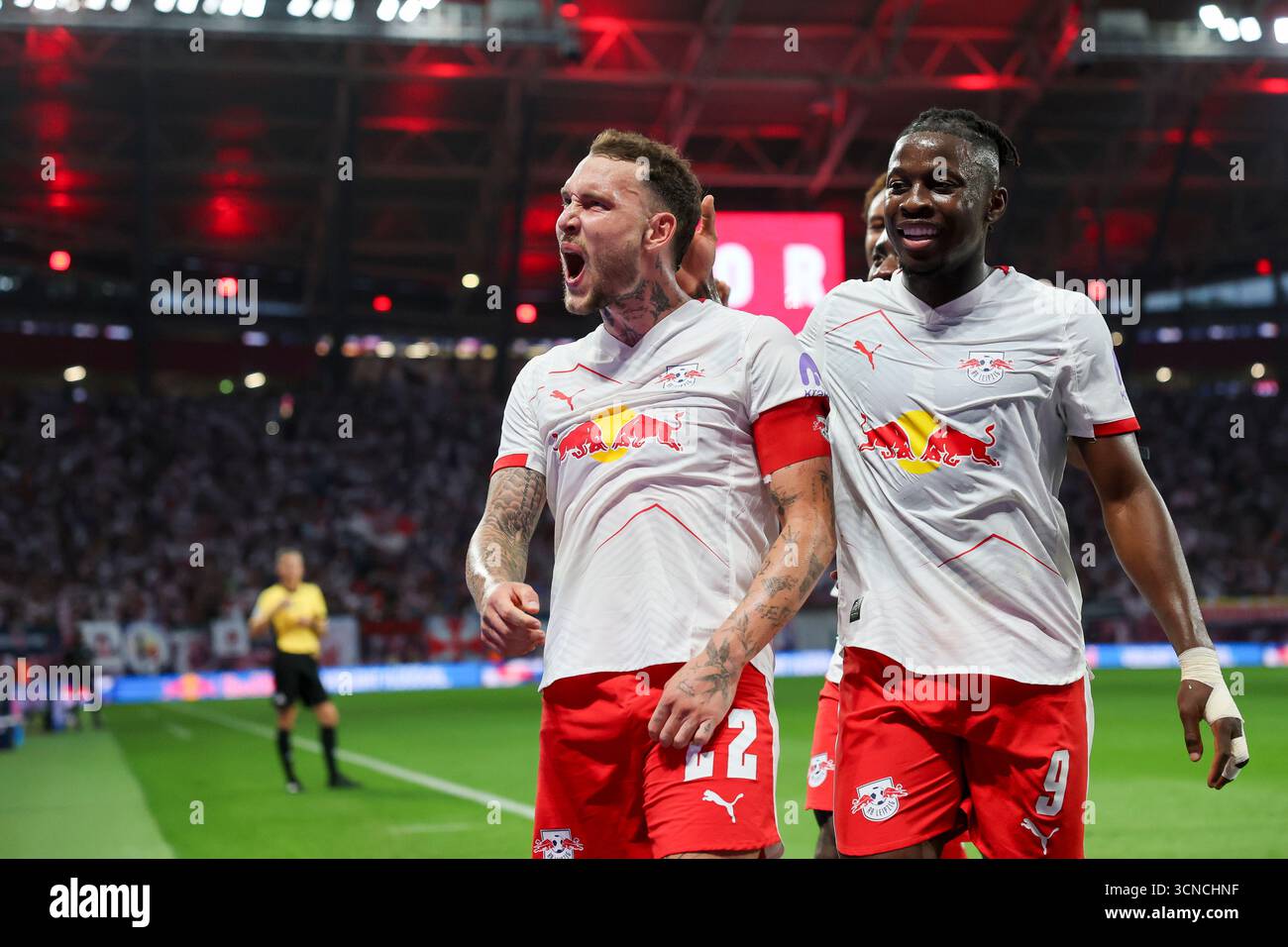 Leipzig's David Raum, left, celebrates scoring their side's third goal ...
