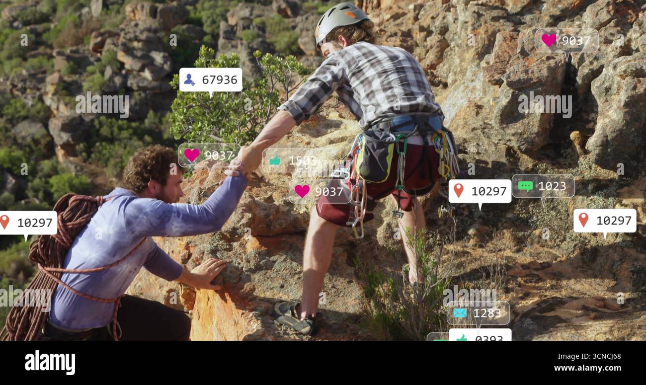 Helping climbing partners ascend rocky hillside, with climbing rope ...