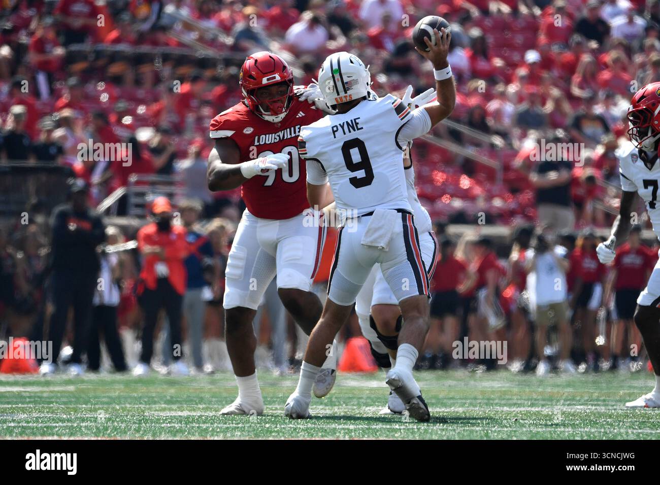 Louisville defensive lineman Rene Konga (90) puts pressure on Bowling ...
