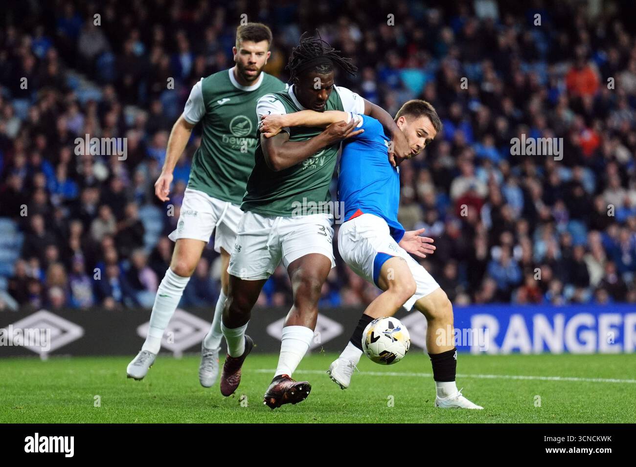 Hibernian's Rocky Bushiri (left) and Rangers’ Nicolas Raskin battle for ...