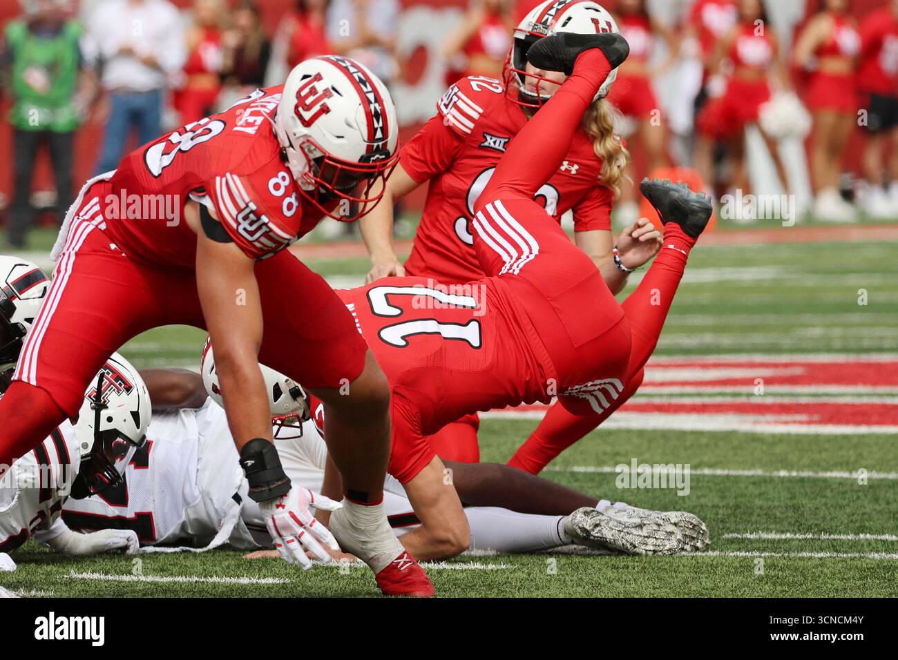 Utah place kicker Dillon Curtis is roughed during a field goal attempt ...